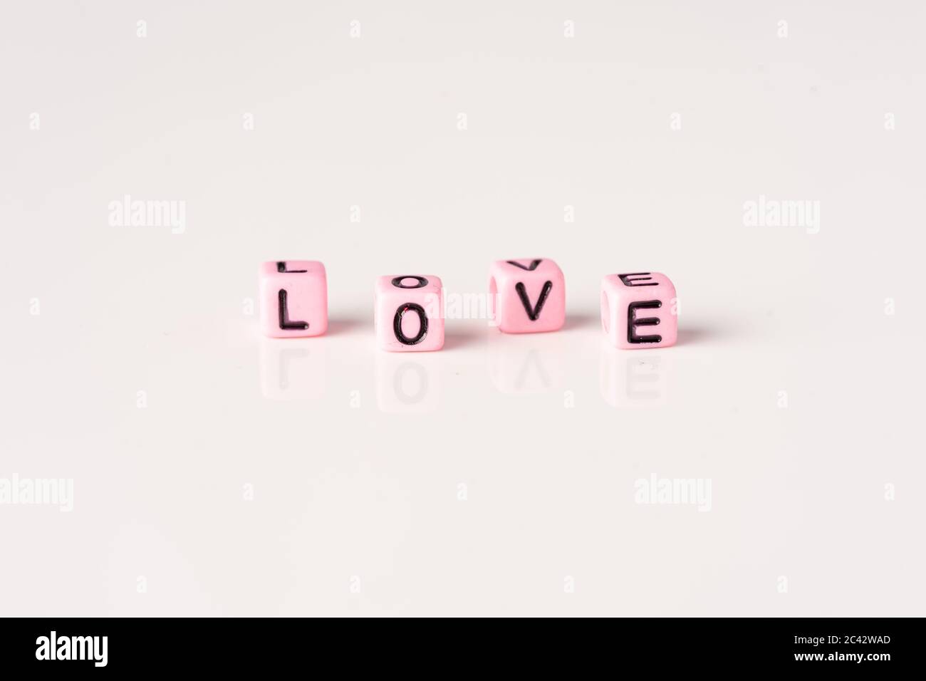 Love concept. Miniature couple against pink background Stock Photo - Alamy