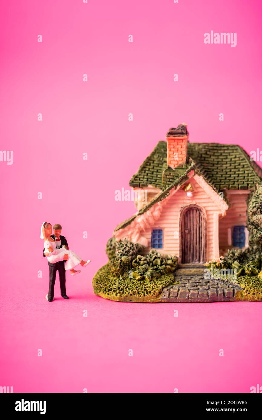 Love concept. Miniature couple against pink background Stock Photo - Alamy