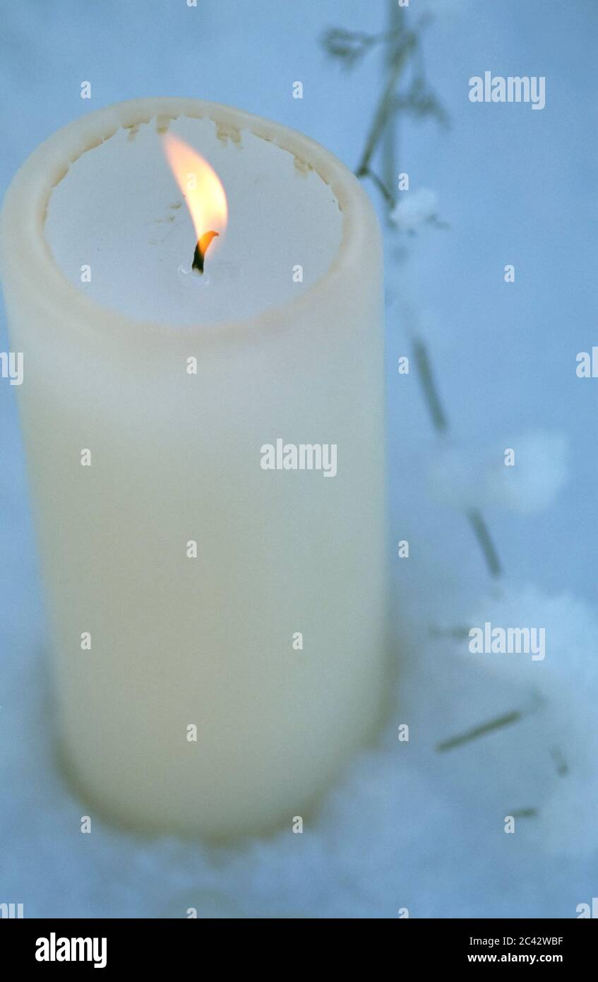 A candle outside in the snow Stock Photo - Alamy