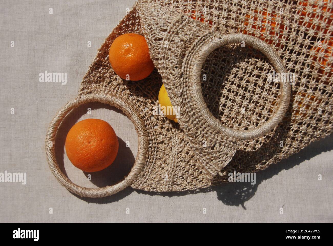 Oranges in a straw bag Stock Photo - Alamy
