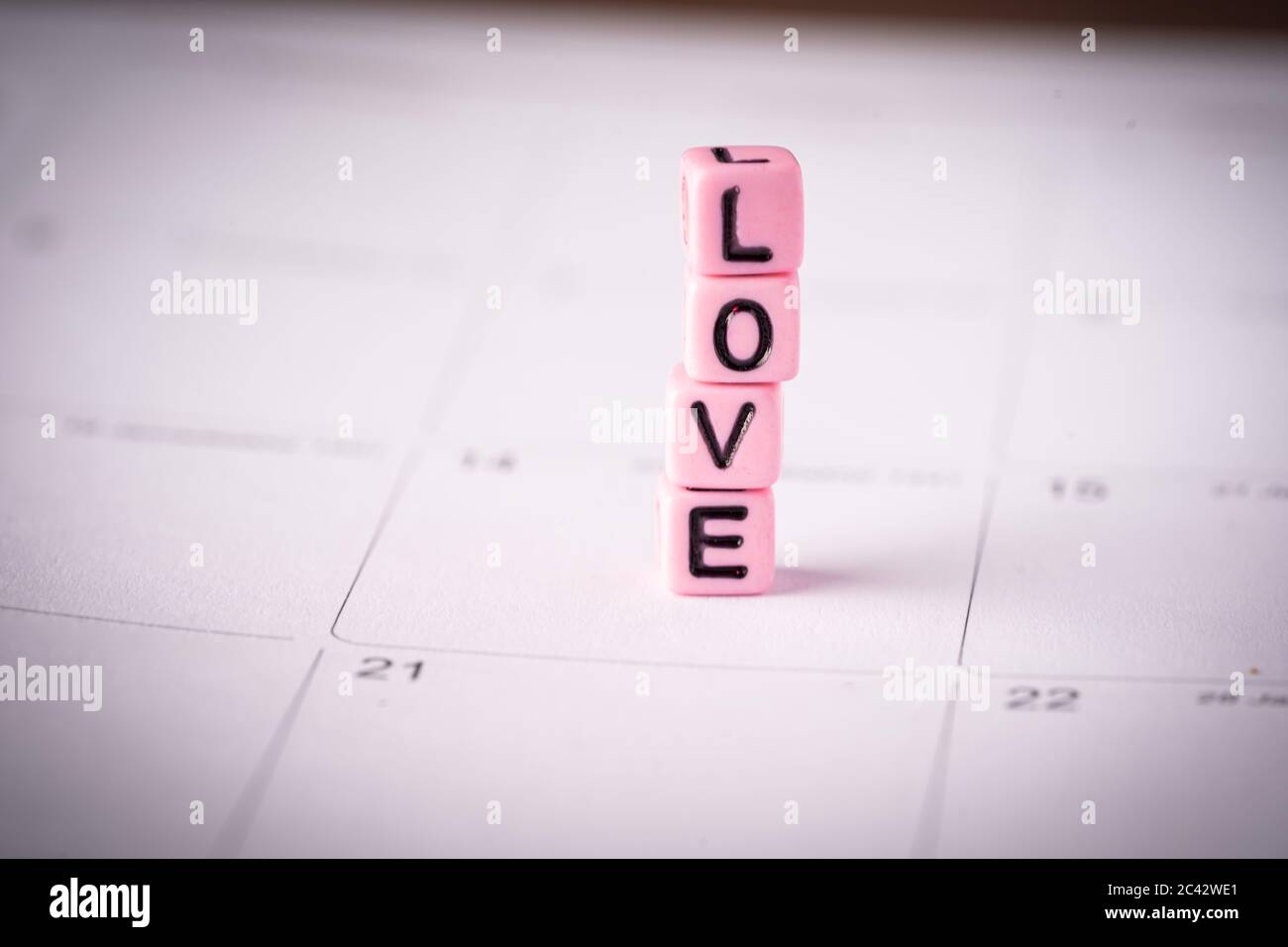 Love concept. Miniature couple against pink background Stock Photo - Alamy