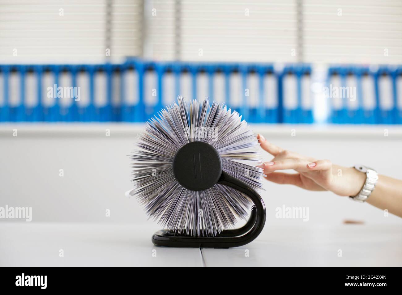 Hand of a woman at a Rolodex office secretary Stock Photo - Alamy