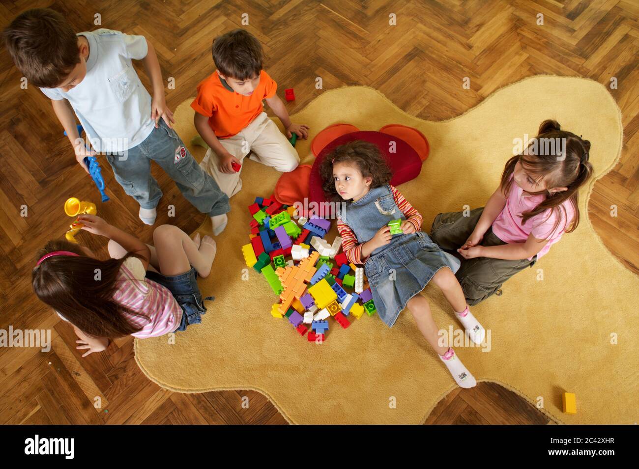 Five children play on the parquet floor - kindergarten - childhood ...