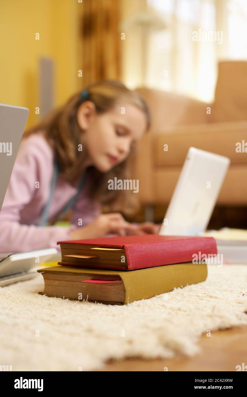 Little girl is doing her chores with a laptop - technology age Stock ...