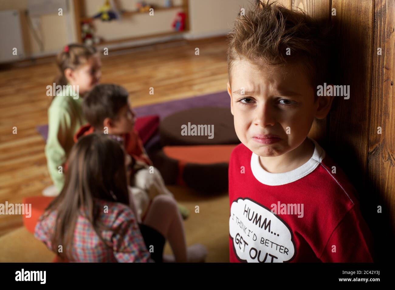 Little boy stands apart from the other children - outsider ...