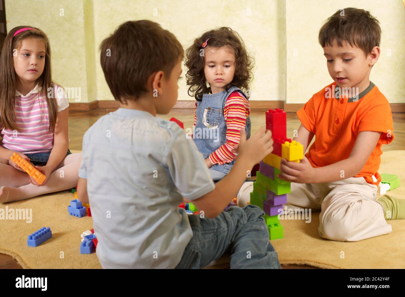 Four children play on the parquet floor - kindergarten - childhood ...