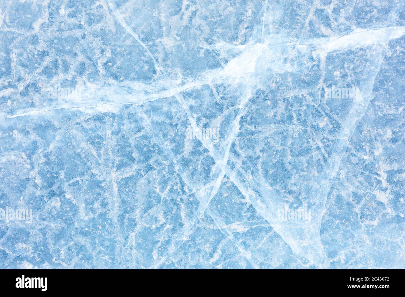 Surface of winter ice on Baikal lake in Siberia . Blue background of ...