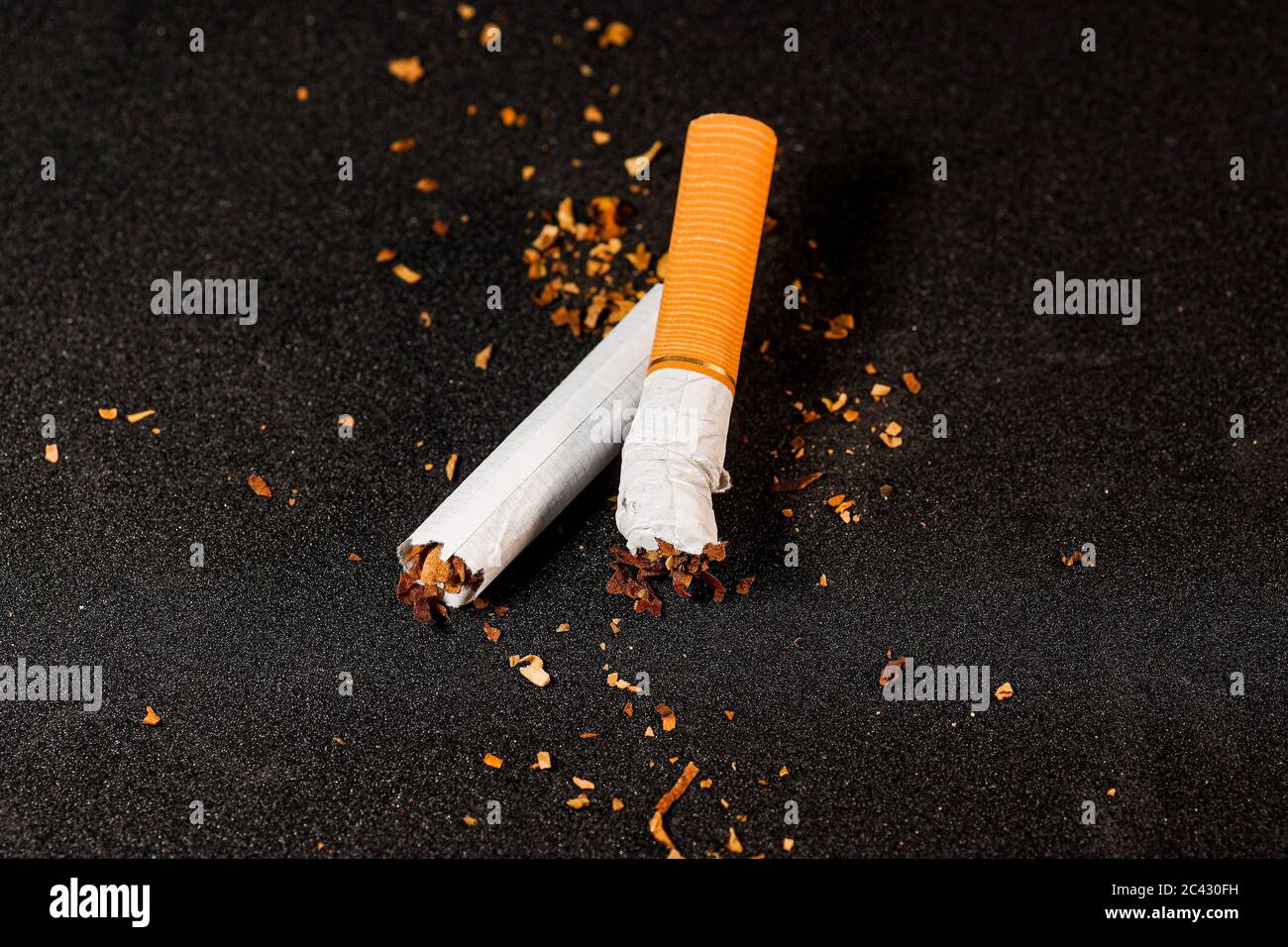 stop smoking concept, a broken cigarette isolated against black, World ...