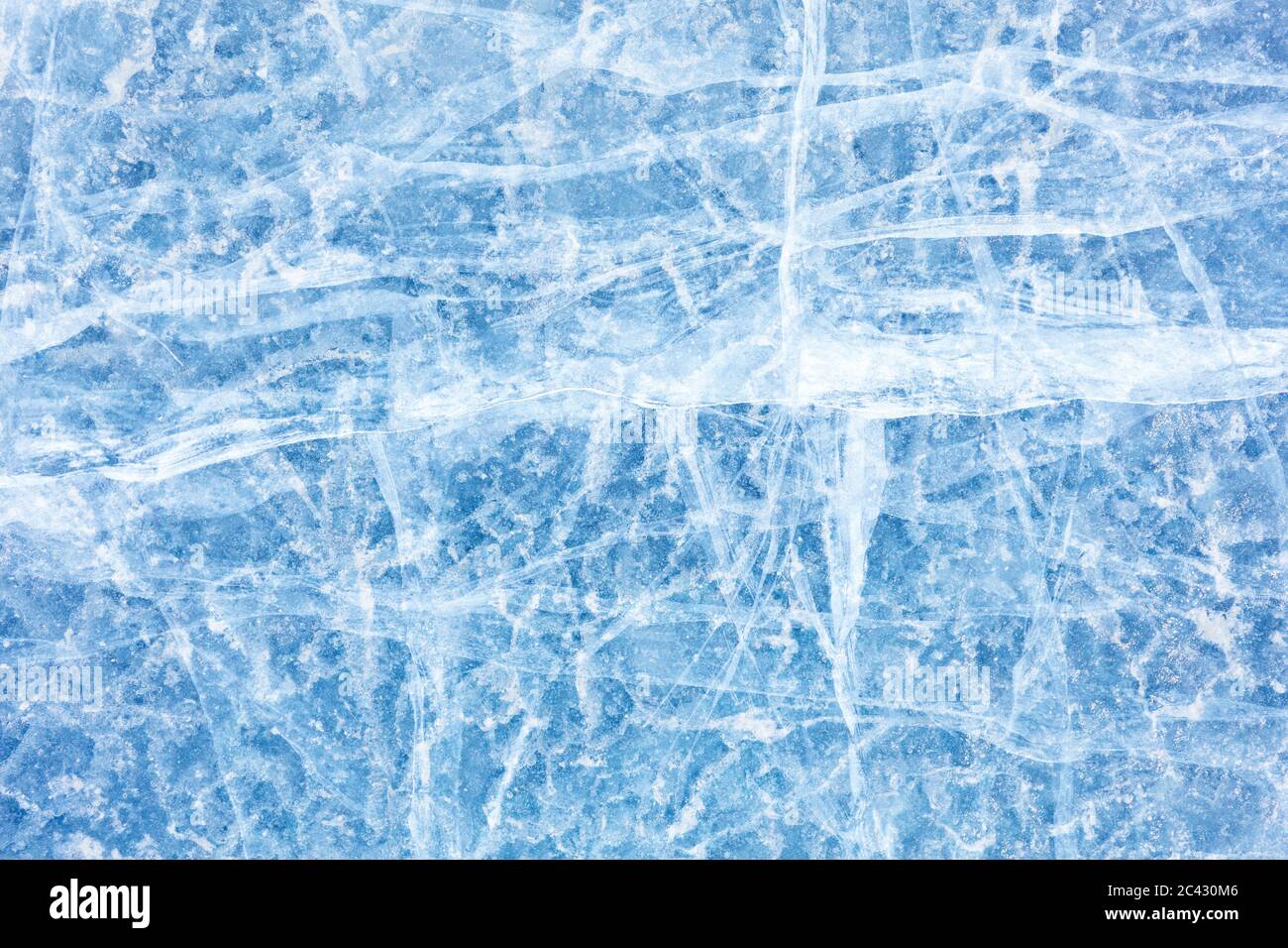 Surface of winter ice on Baikal lake in Siberia . Blue background of ...