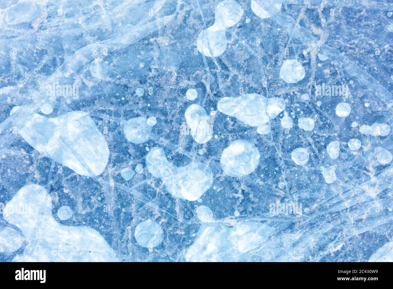 Surface of winter ice on Baikal lake in Siberia . Blue background of ...