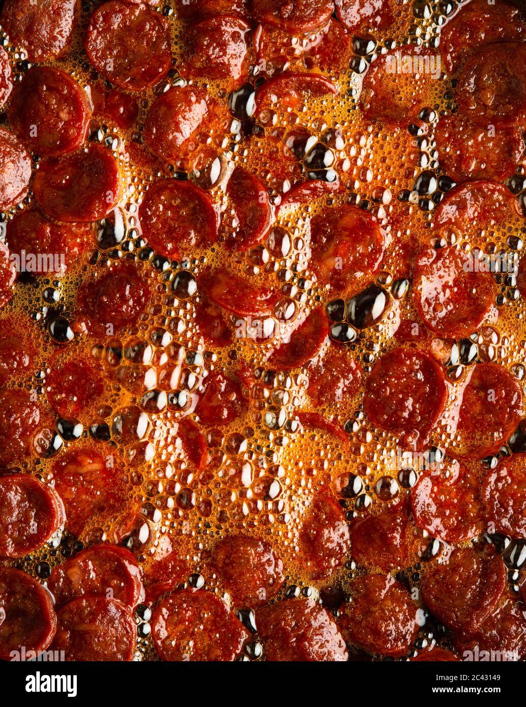 Chorizo frying in oil Stock Photo - Alamy