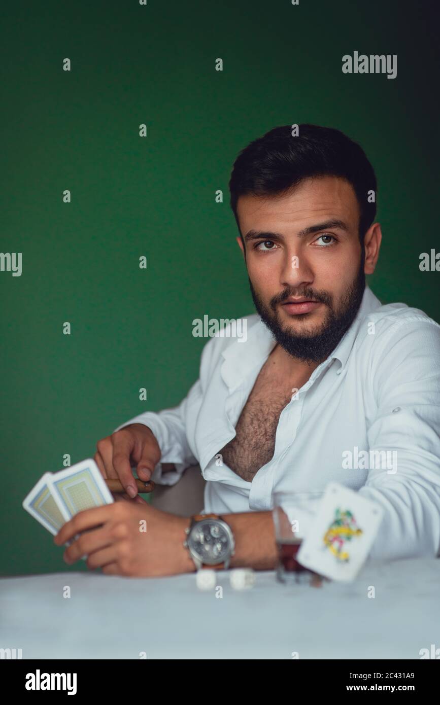 Gambler man portrait in green background. Green Screen Stock Photo - Alamy