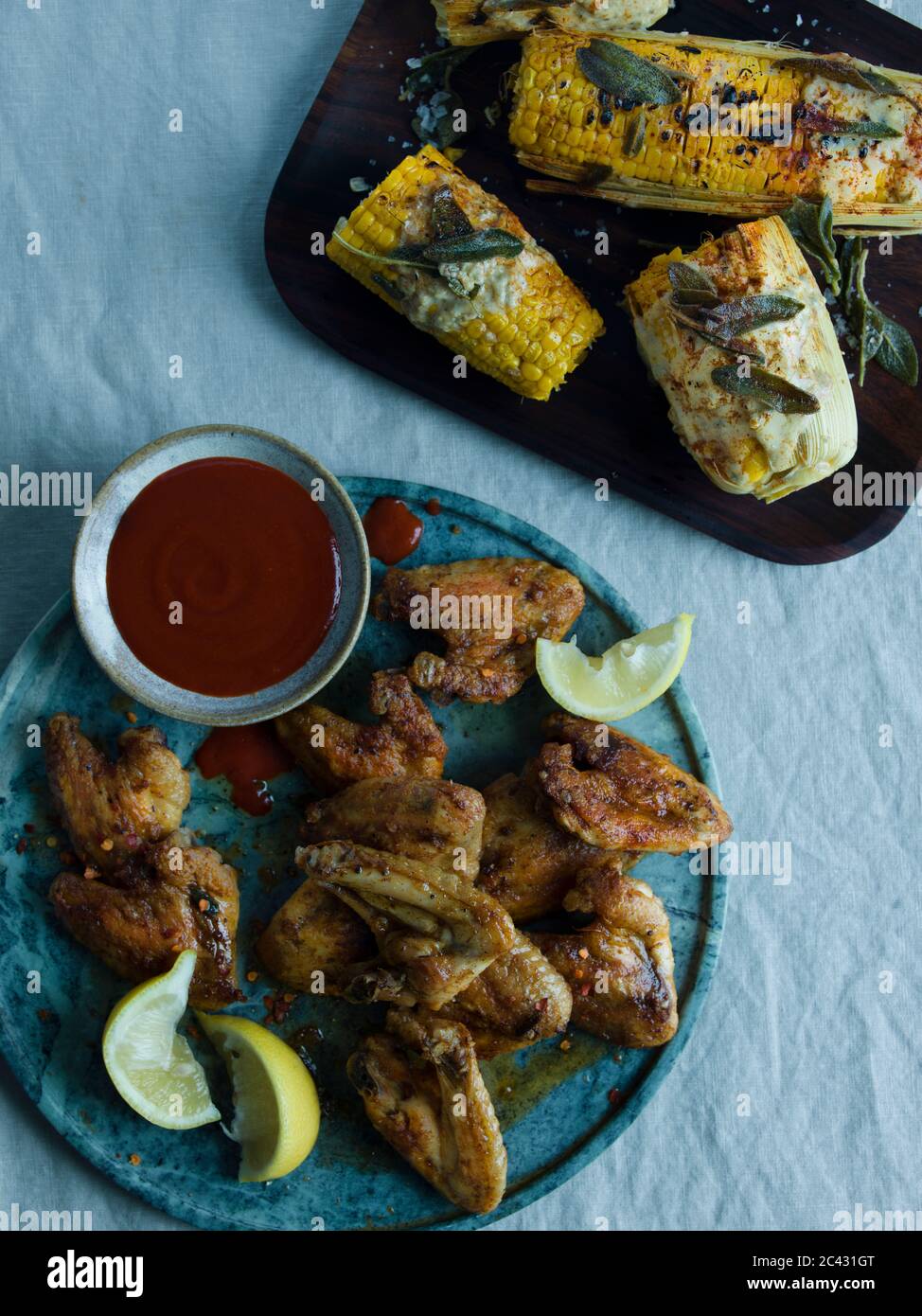 Chicken Wings and Grilled Corn Stock Photo - Alamy