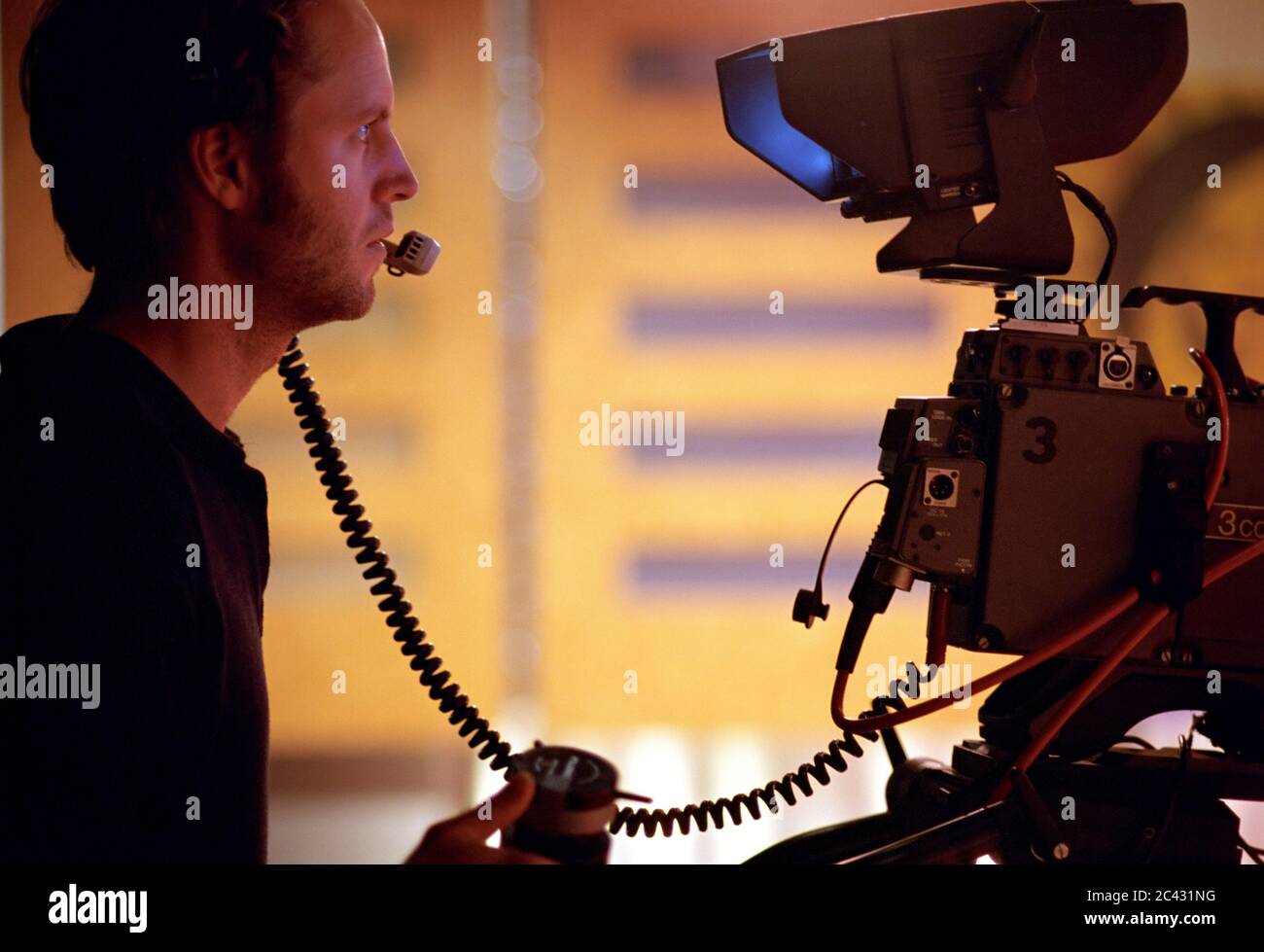 A cameraman with the camera running in a television studio - media - TV ...