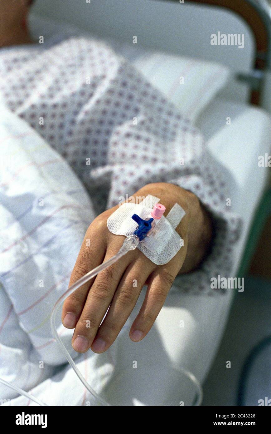 Patient (detail) with infusion on the back of his hand - hospital Stock ...