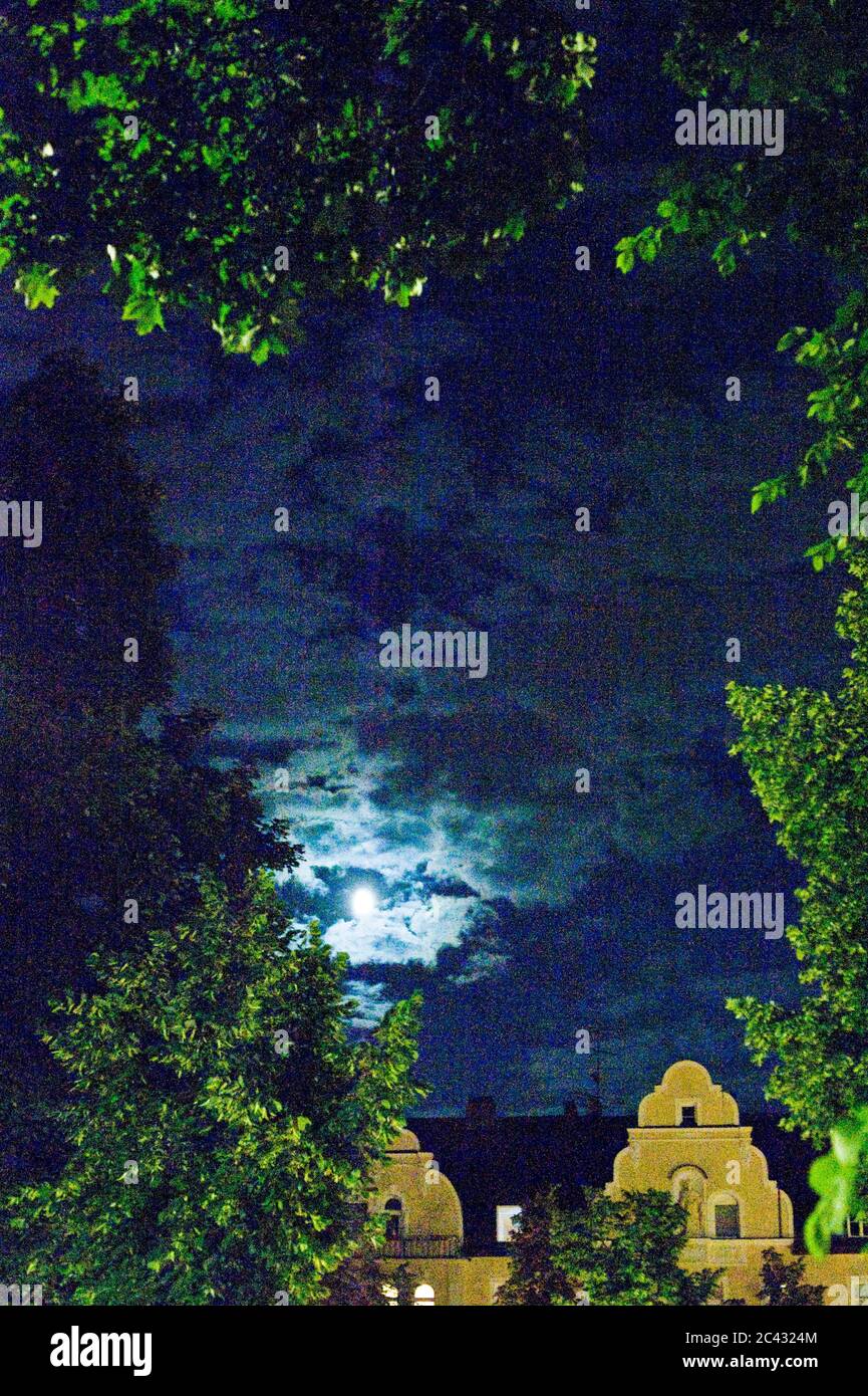 Full moon between clouds, Munich, Bavaria, Germany Stock Photo - Alamy