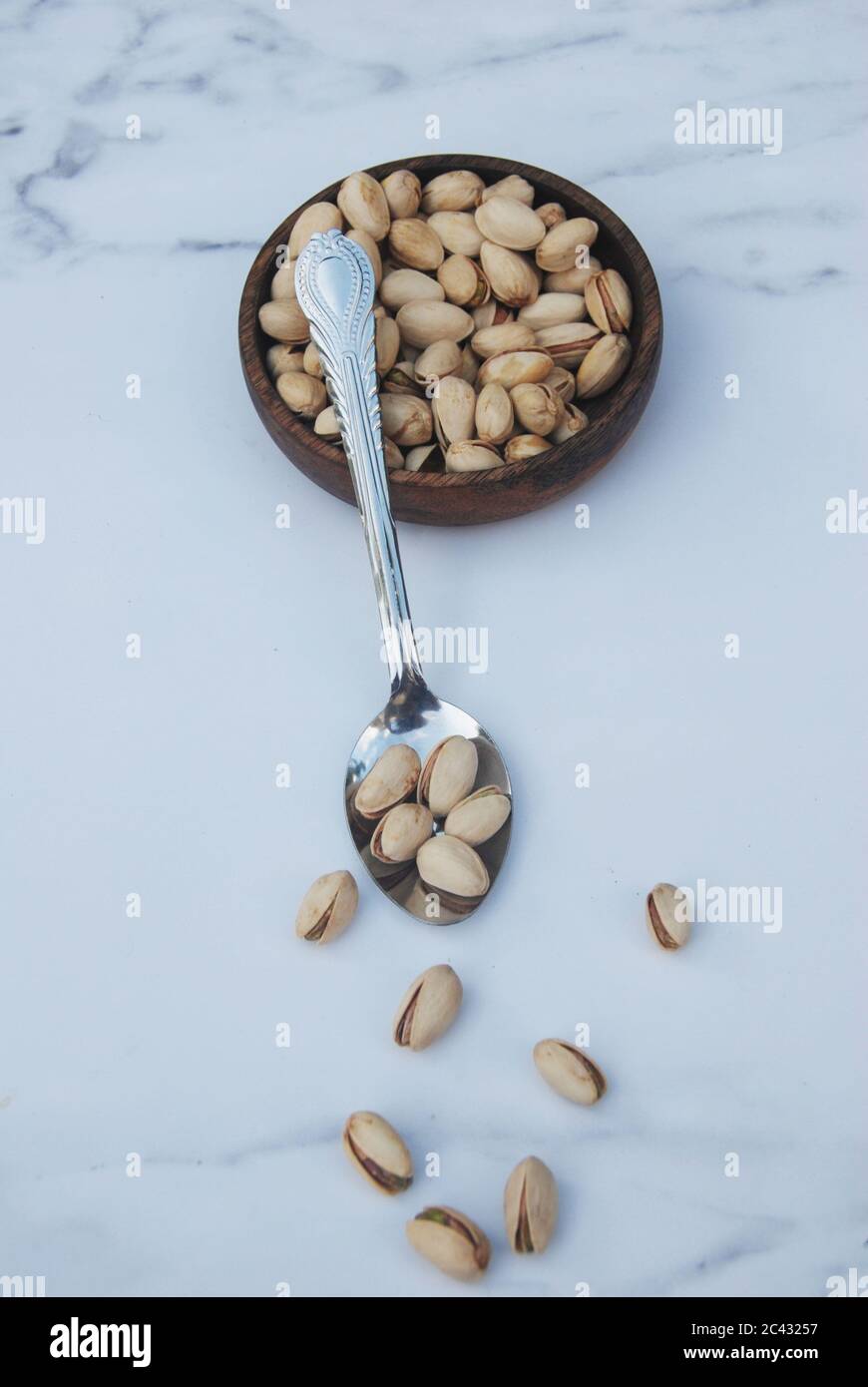 Spoon full of Pistachio Nuts Stock Photo - Alamy