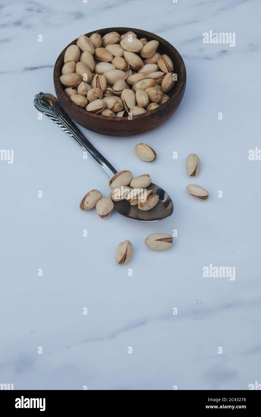 Spoon full of Pistachio Nuts Stock Photo - Alamy