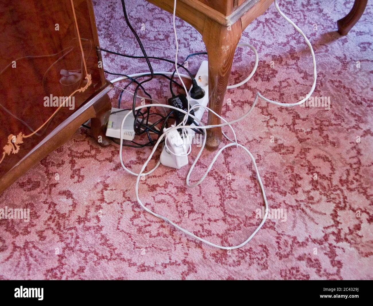Tangled cables on a power strip Stock Photo - Alamy