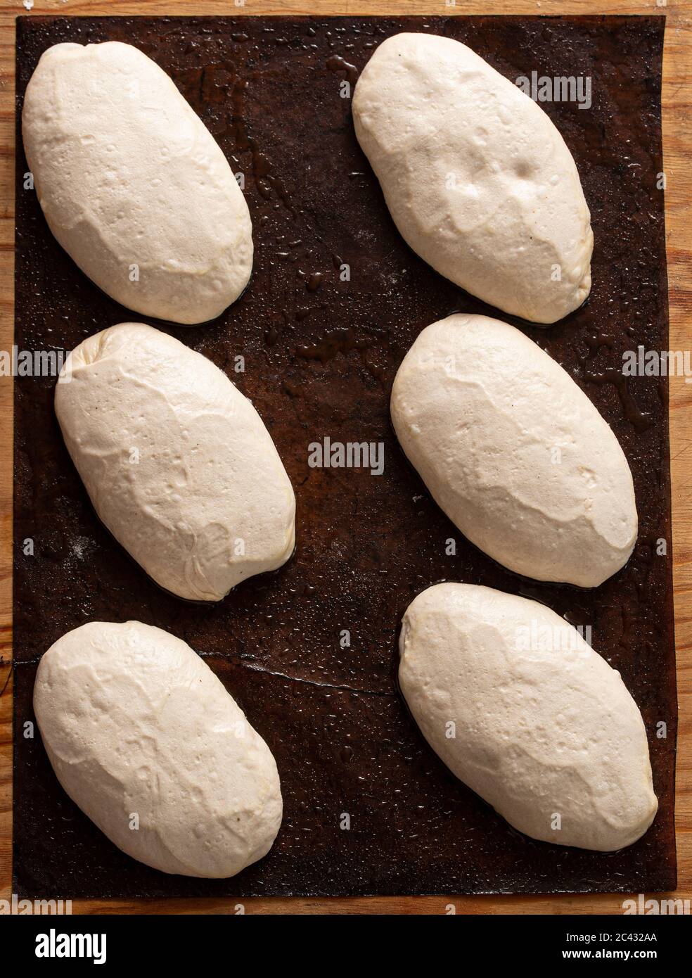Pre shaped bread dough on baking sheet Stock Photo - Alamy