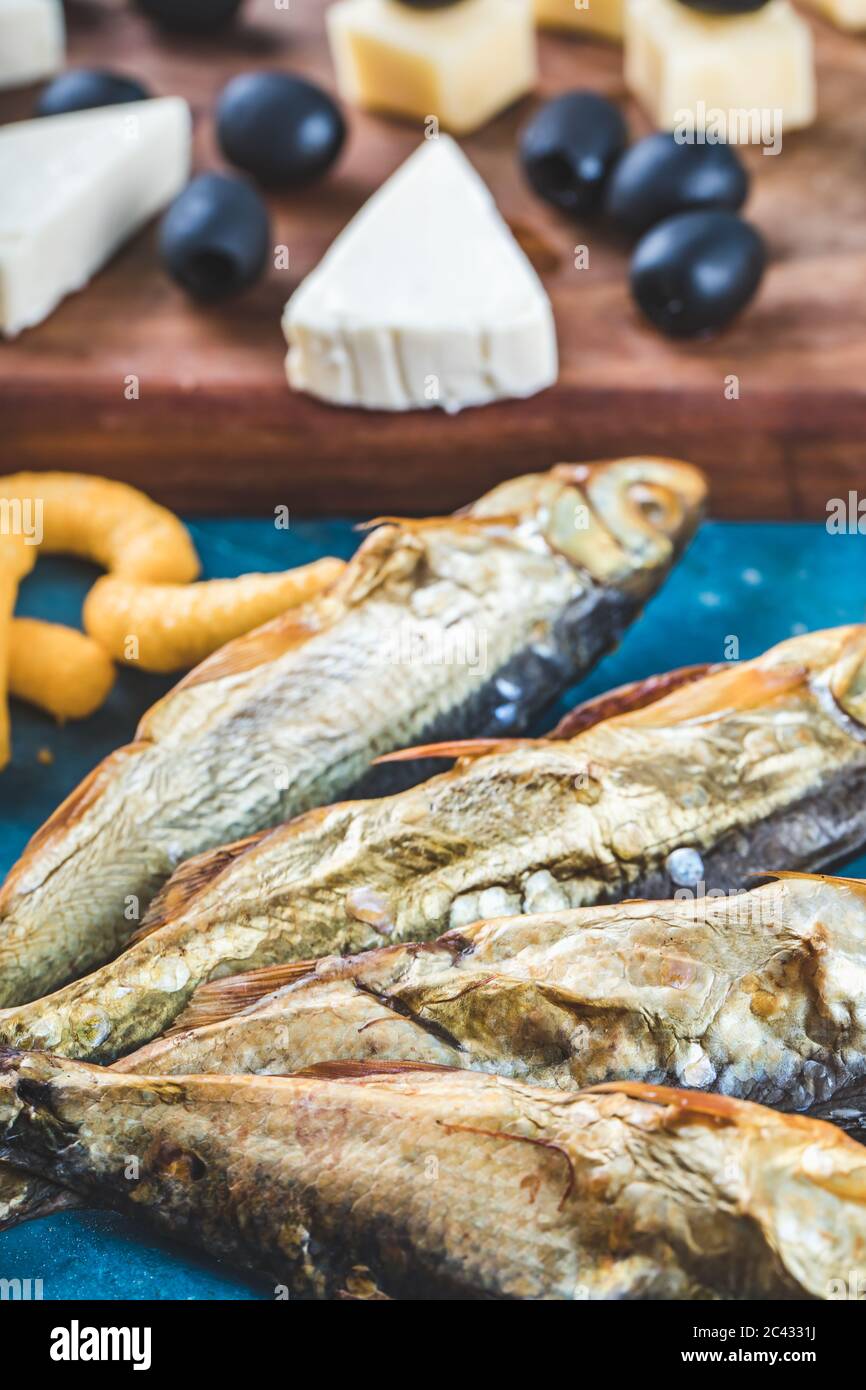 Dry fish snacks servd with cheese and crackers Stock Photo - Alamy