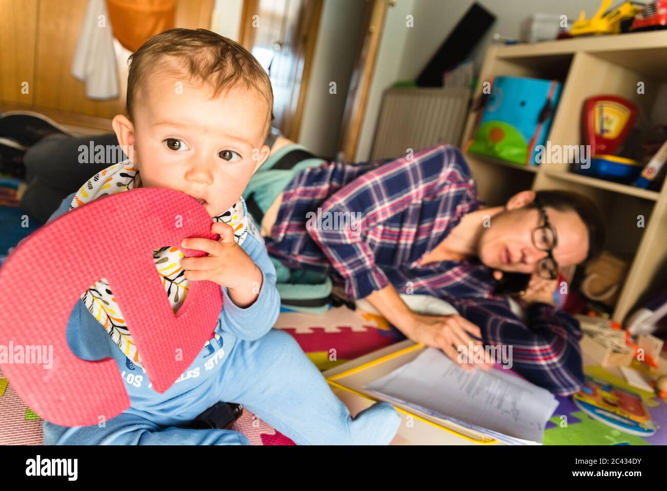 Divorced woman working alone on her computer while entertaining her ...