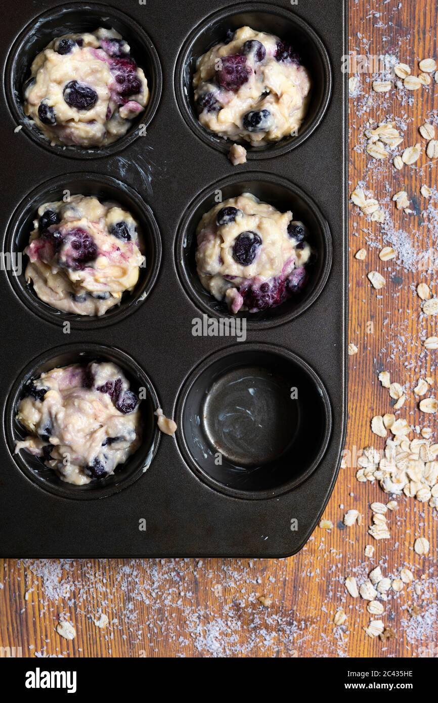 Mixed berry and oat muffin batter in a muffin pan Stock Photo - Alamy