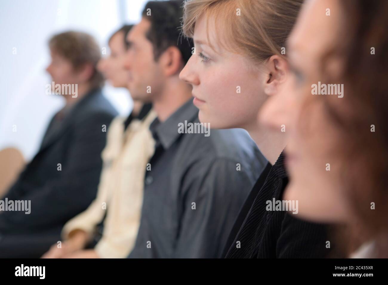 Business people sit in a row Stock Photo - Alamy