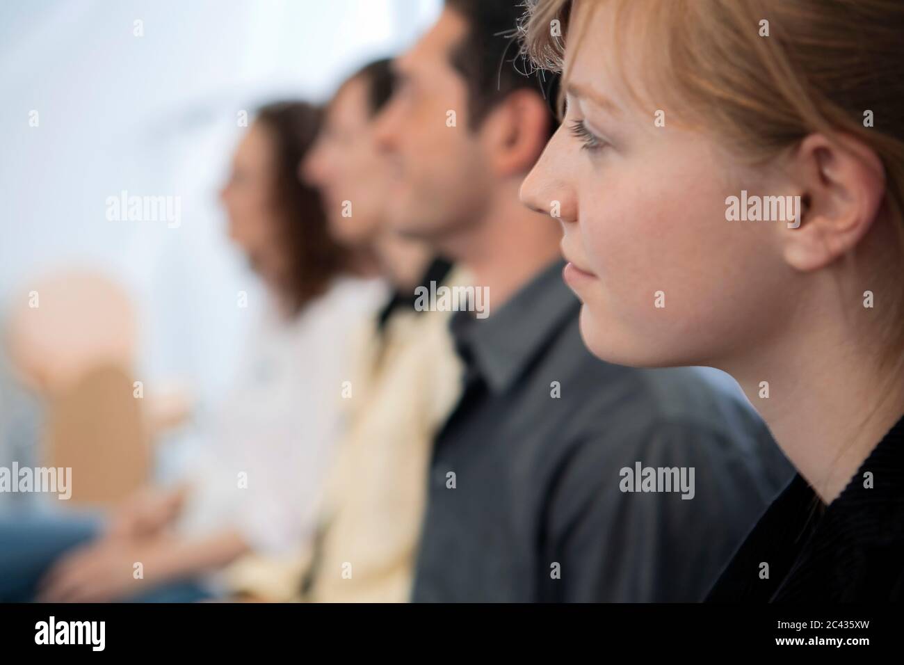 Business people sit in a row Stock Photo - Alamy