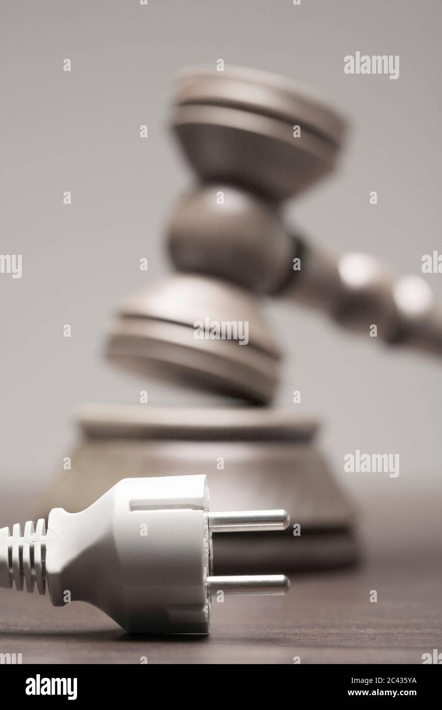 Power plug in front of a judge gavel Stock Photo - Alamy