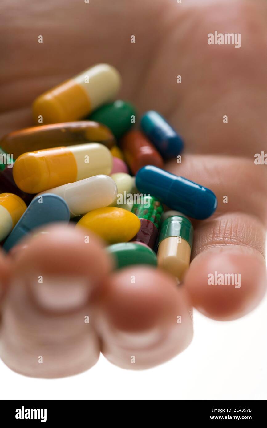 Different capsules in one hand Stock Photo - Alamy