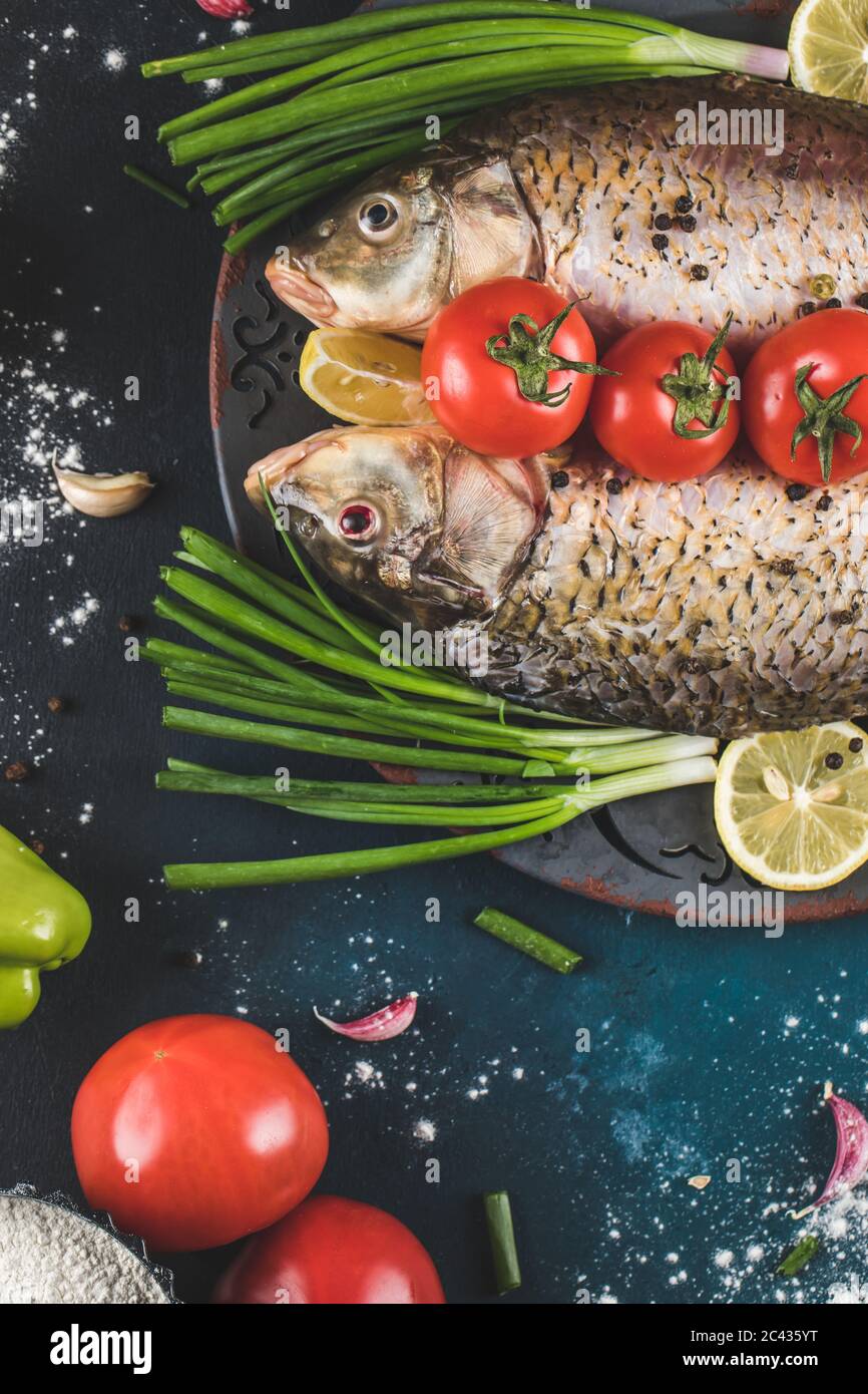 Fish meat ready for cooking with lemon, vegetables and spices Stock ...