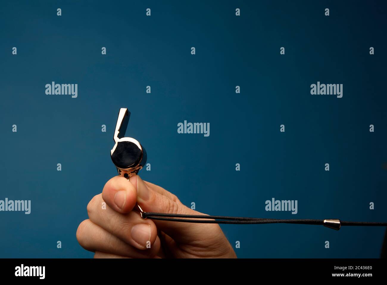 Hand holds whistle Stock Photo - Alamy