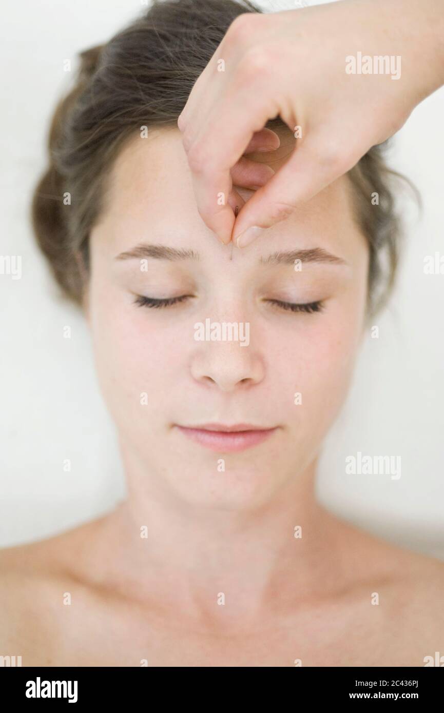 Young woman doing acupuncture Stock Photo - Alamy