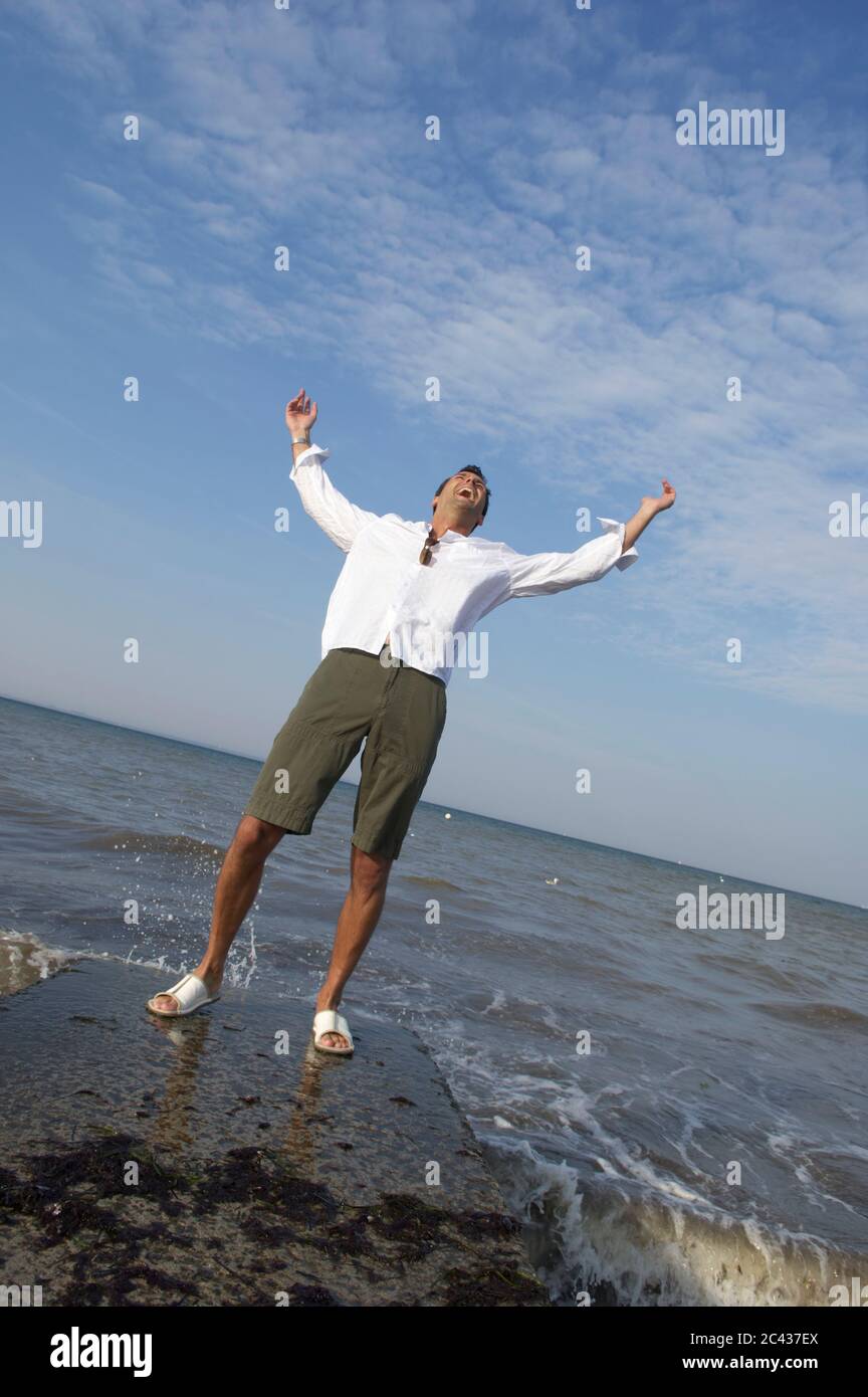 Man cheers on the beach Stock Photo - Alamy