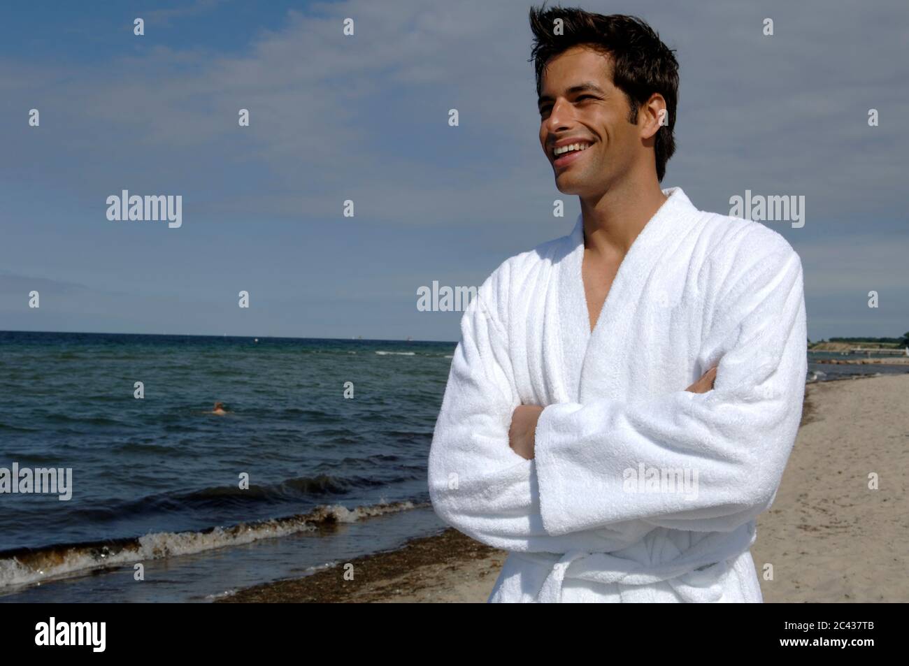 Man in a bathrobe on the beach Stock Photo - Alamy