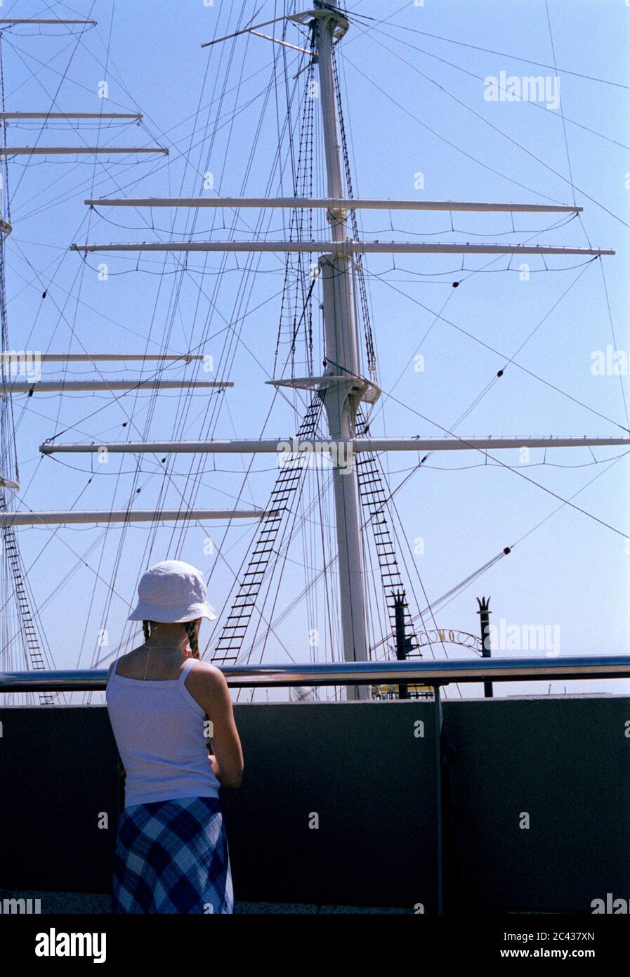 Girl looks at sailing ship Stock Photo - Alamy