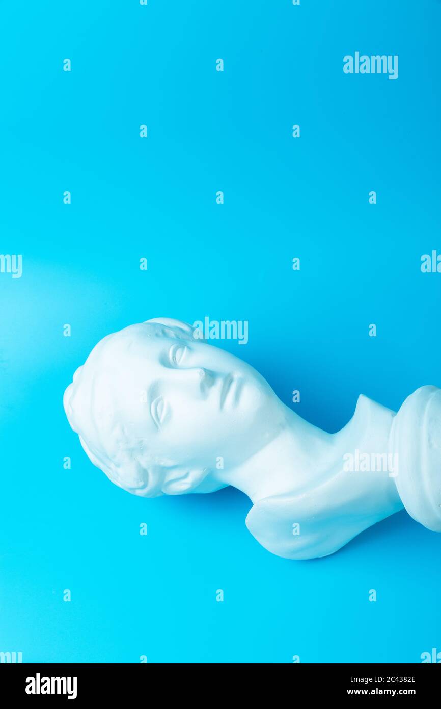 Girlish Venus plaster head on blue background Stock Photo - Alamy