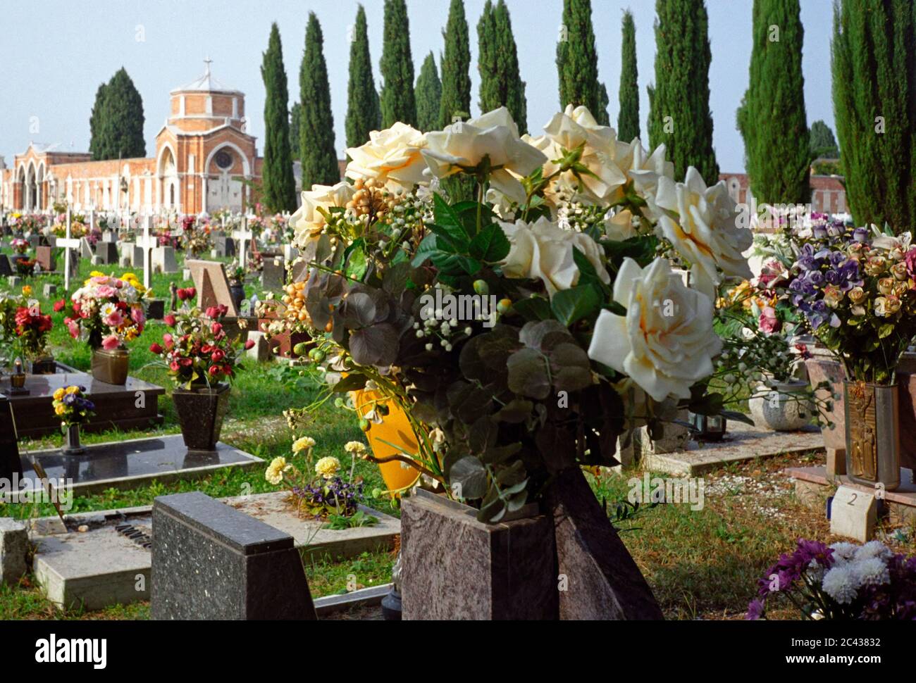 A bouquet of white roses in front of a cemetery - commemoration ...