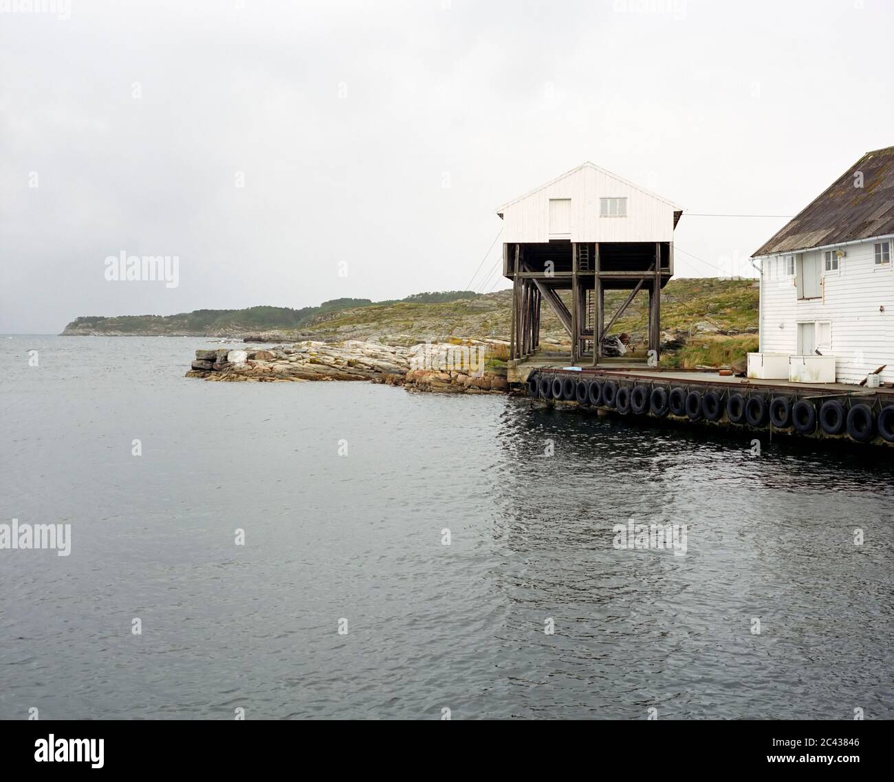 A pile dwelling stands next to a house - house building - coast Stock ...