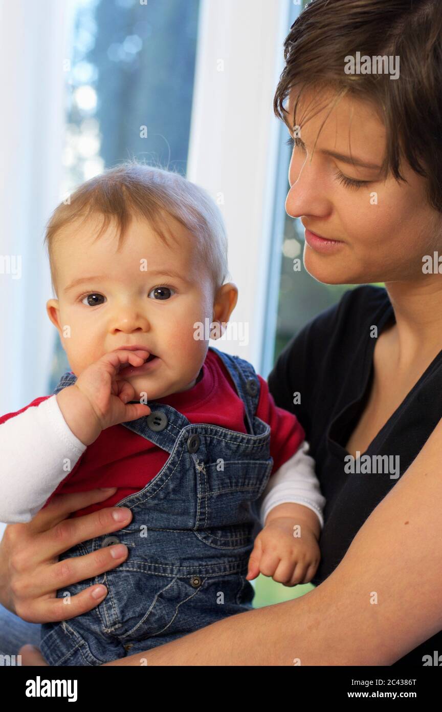 Mother with her baby in her arms - family - offspring Stock Photo - Alamy