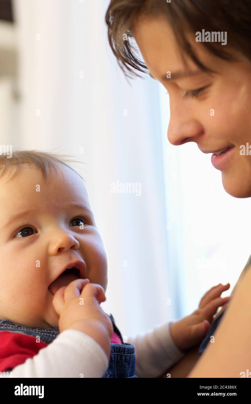 Mother with her baby in her arms - family - offspring Stock Photo - Alamy