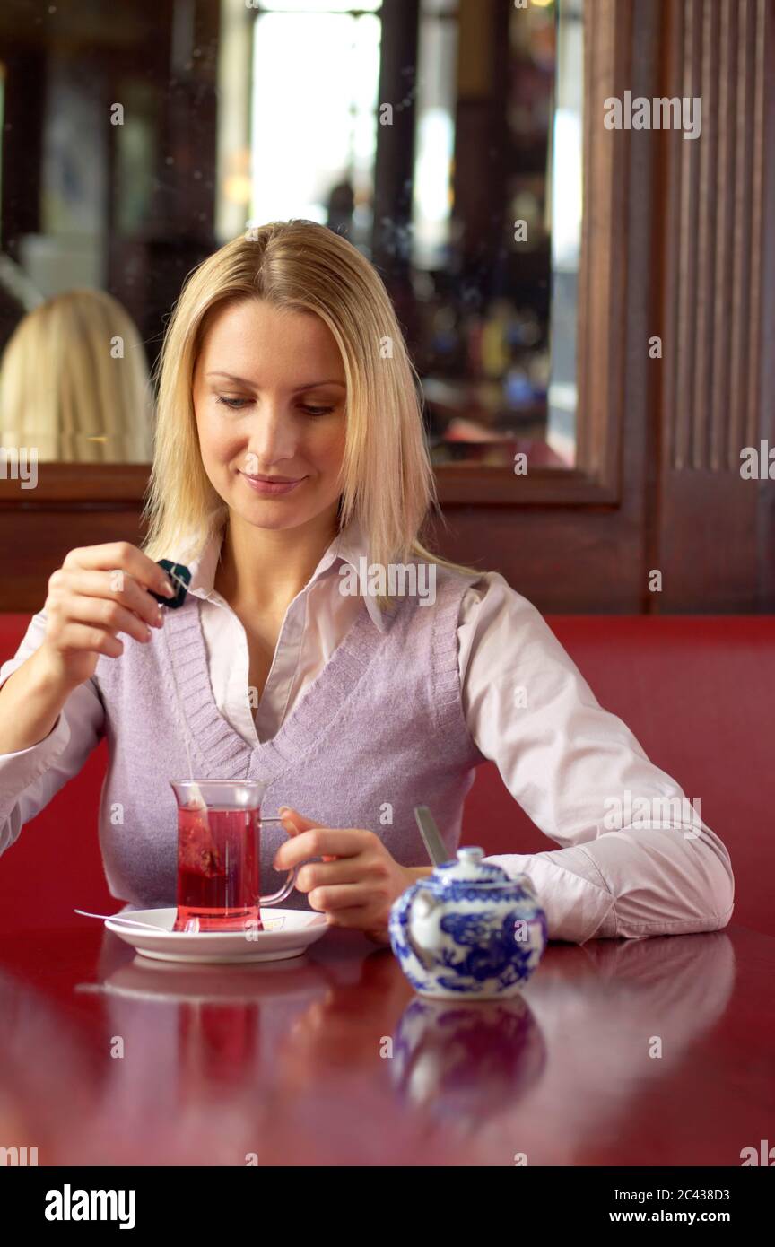 Woman takes a tea bag from a cup Stock Photo - Alamy
