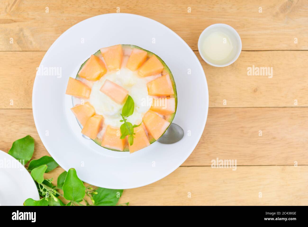 Melon Bingsu with Sweetened Condensed Milk on wood table Stock Photo ...