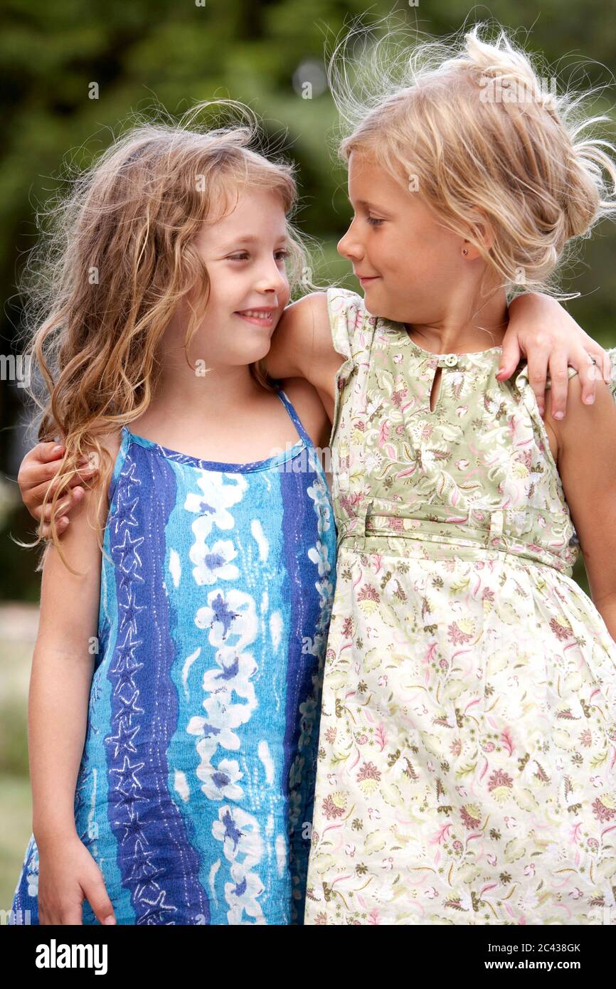 Two girls arm in arm Stock Photo - Alamy