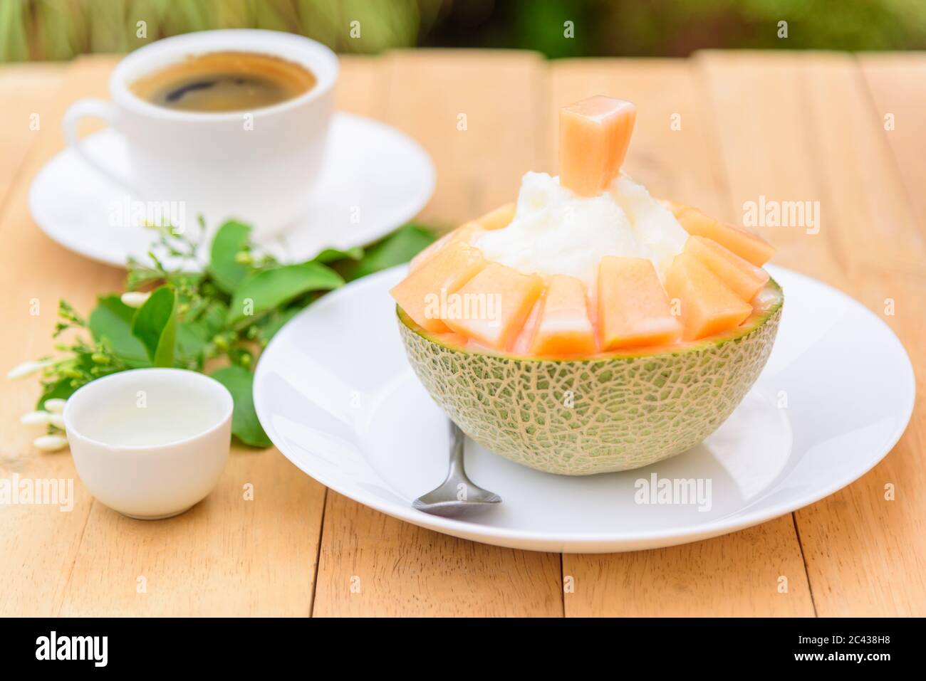 Melon Bingsu with Sweetened Condensed Milk on wood table Stock Photo ...
