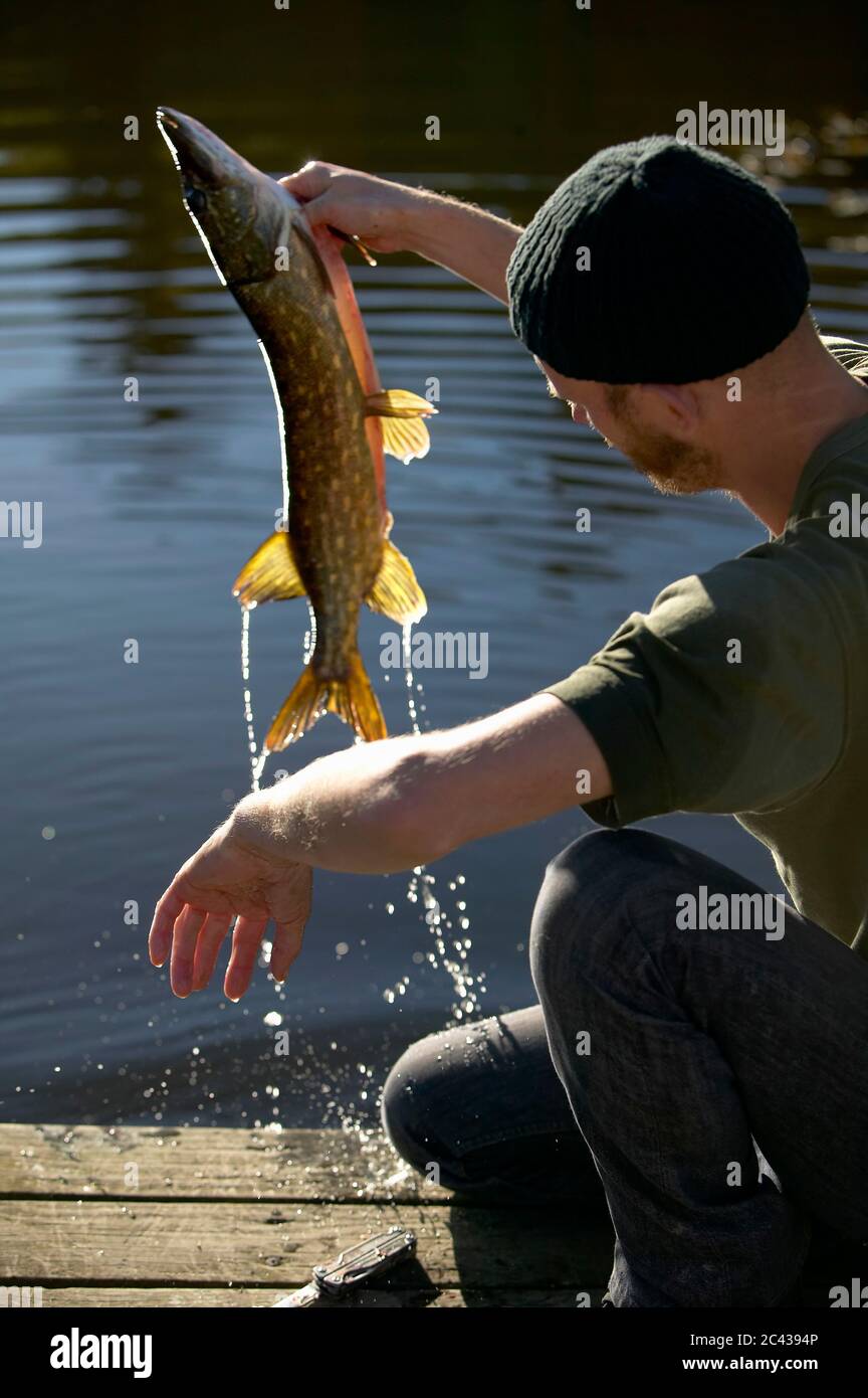 Holds a fish hi-res stock photography and images - Alamy