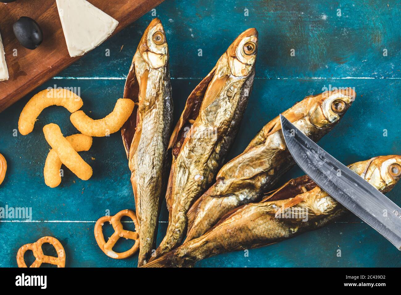 Crackers with smoked fish on the blue table Stock Photo - Alamy