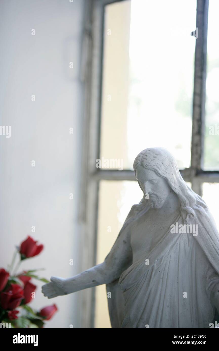 Jesus statue in front of window Stock Photo - Alamy