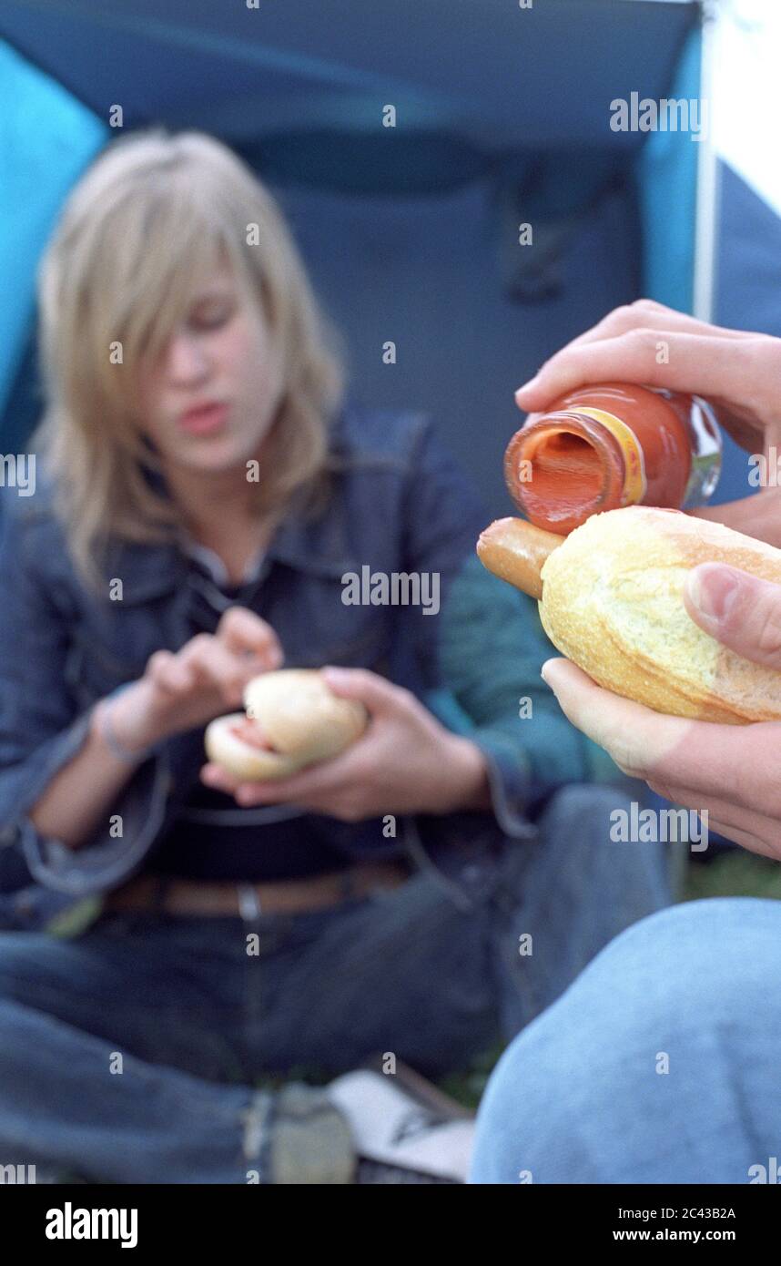 Young people eat sausages Stock Photo - Alamy